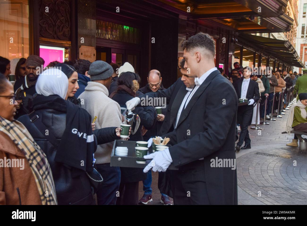 London, UK. 26th December 2023. Members of staff serve pastries and hot ...