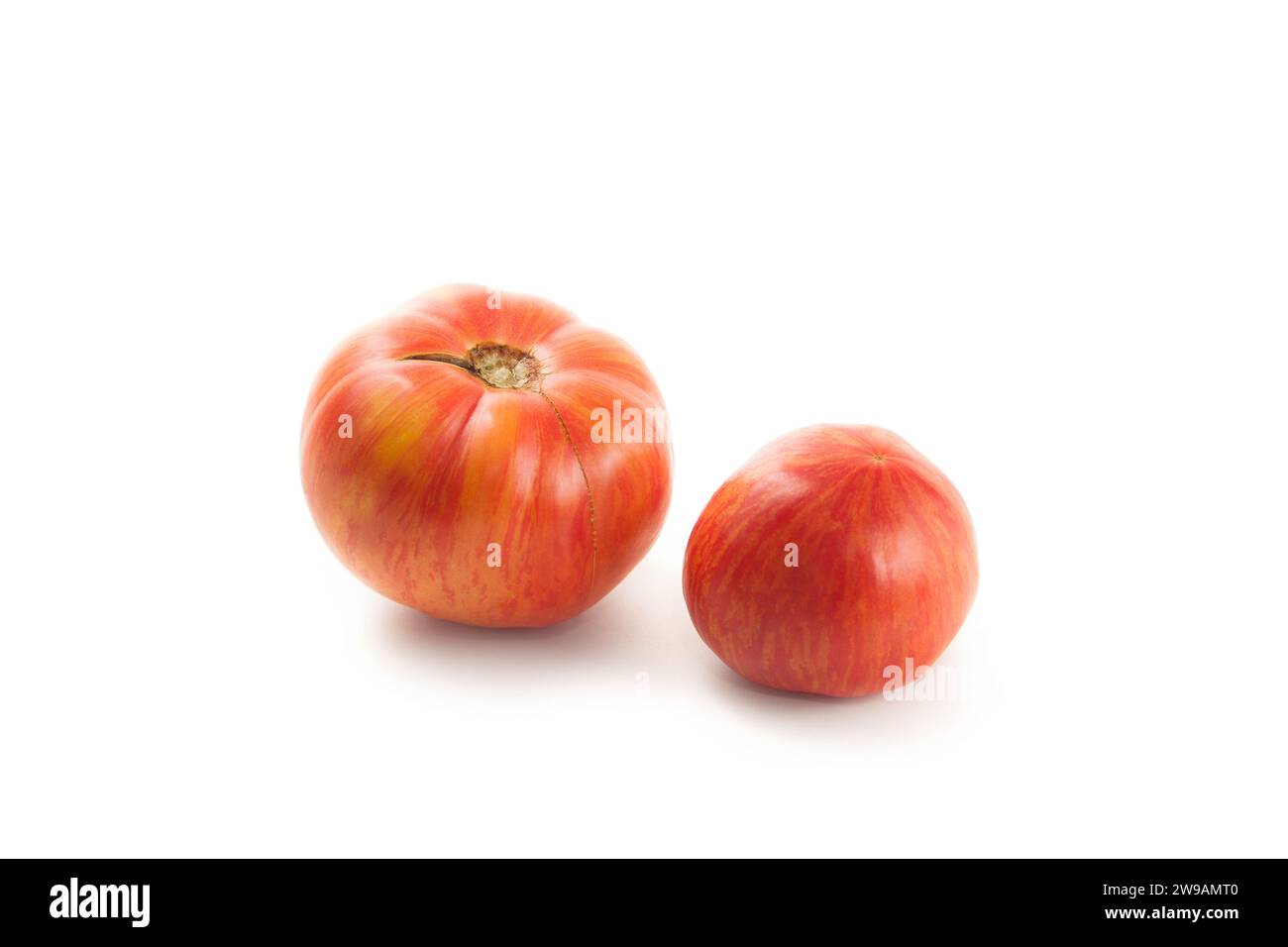 Two whole ripe juicy pink tomatoes with soft shadow isolated on white ...