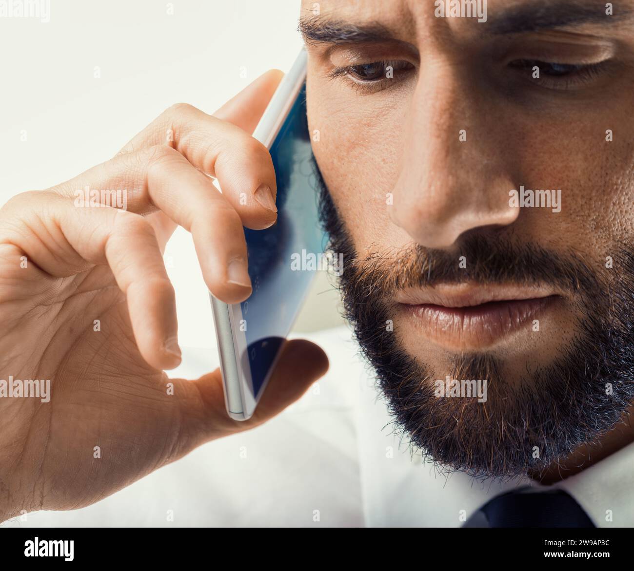 Corporate worker on a phone call, deep in thought and absorbed in the ...