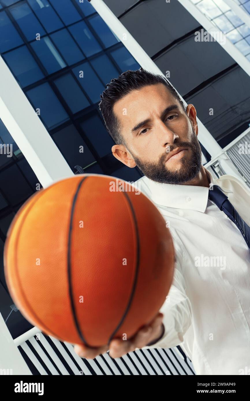 Confident professional uses basketball to represent the importance of ...