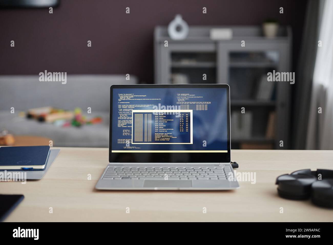 Background image of open laptop with code lines on screen at home ...