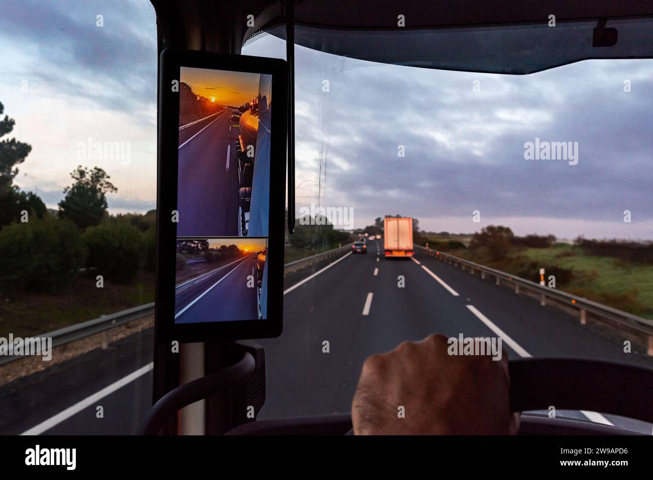 View from the driver's position of a truck on the road of a sunrise ...