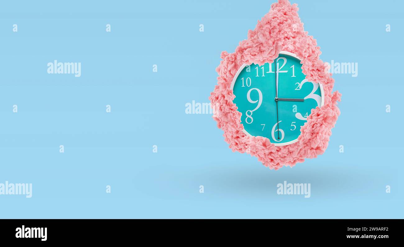 Blue clock in clouds of pink paint isolated on a pastel blue background ...