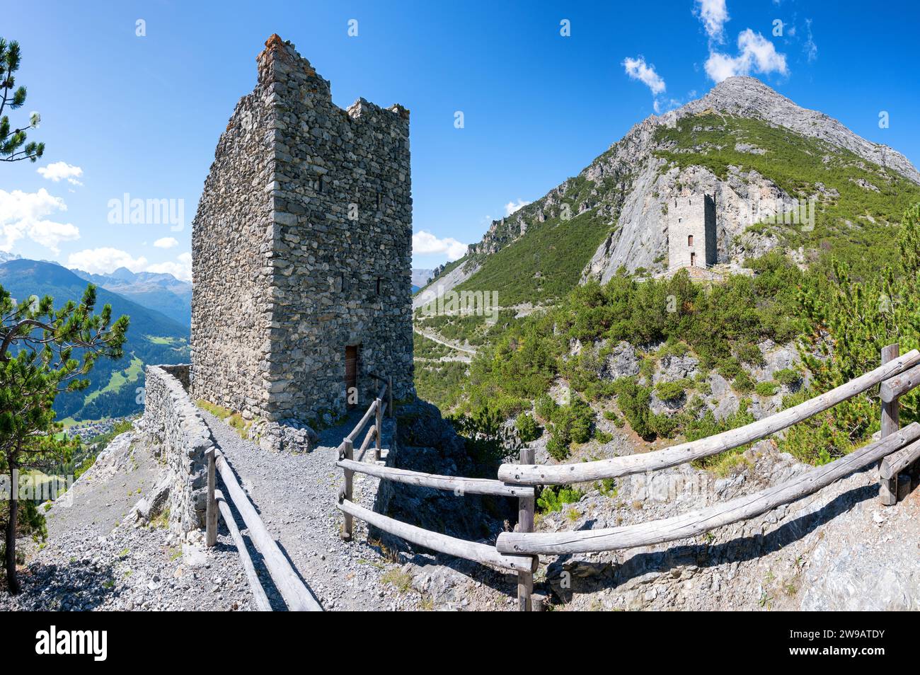 Curvy road and old fortress towers of Cancano near Bormio, Italy Stock ...