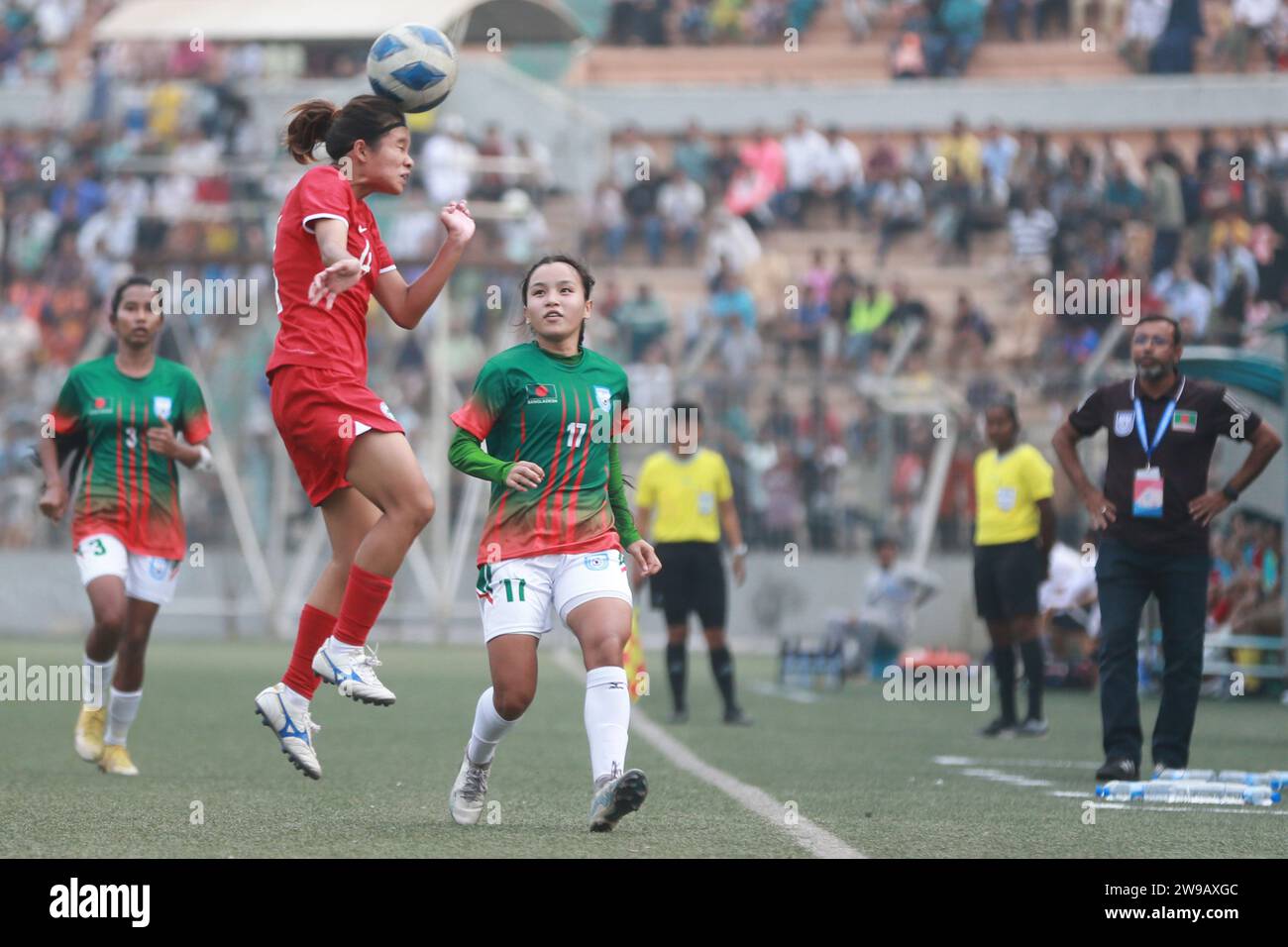 Bangladeshi midfilder Ritu Porna Chakma (Green) try to takes control as ...