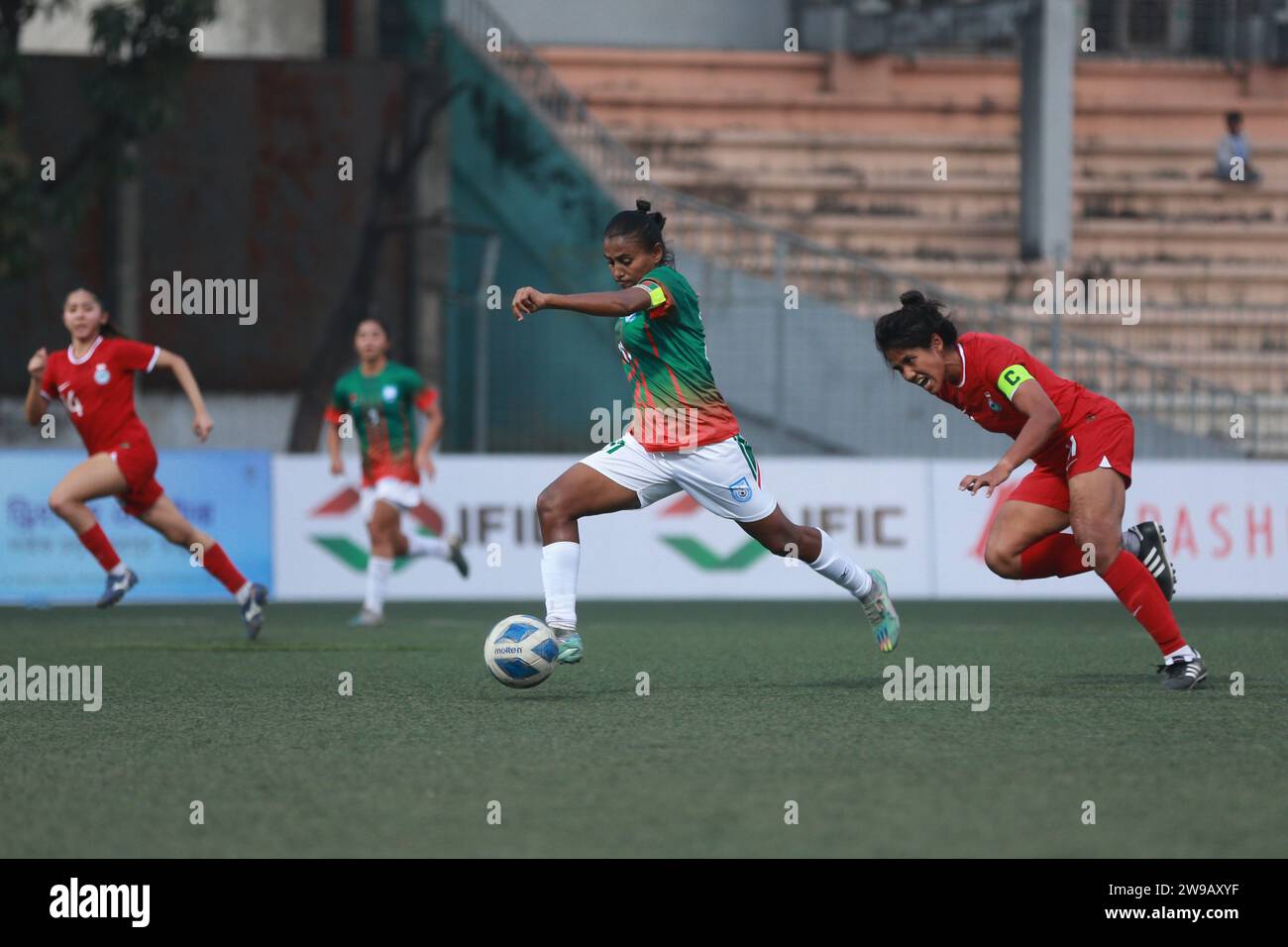 Bangladeshi forward Sabina Khatun (L) in action as Bangladesh national ...