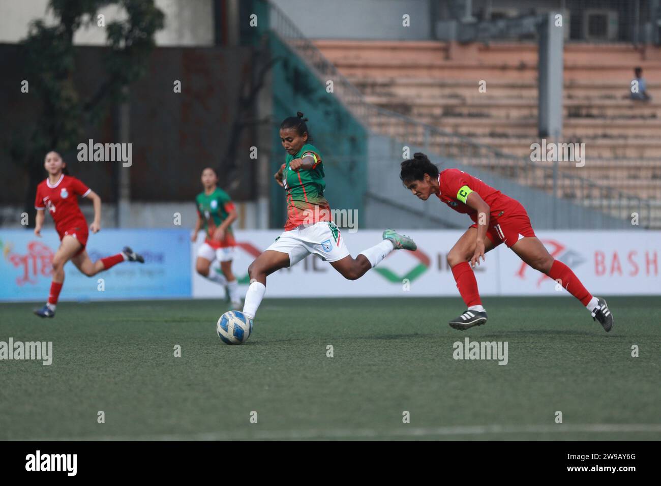 Bangladeshi forward Sabina Khatun (L) in action as Bangladesh national ...