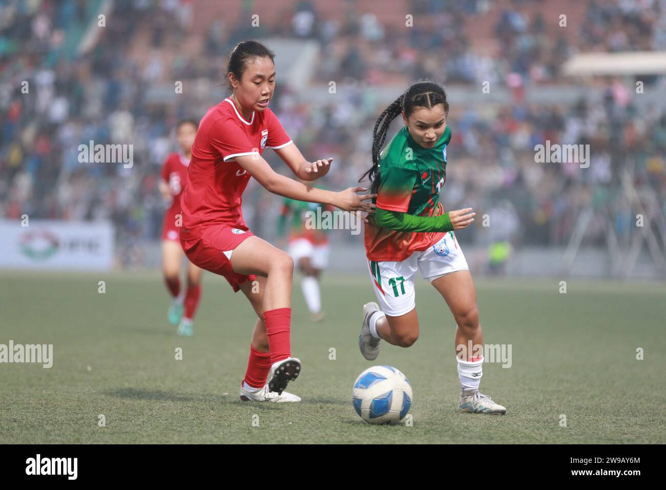 Bangladeshi midfilder Ritu Porna Chakma (Green) try to takes control as ...