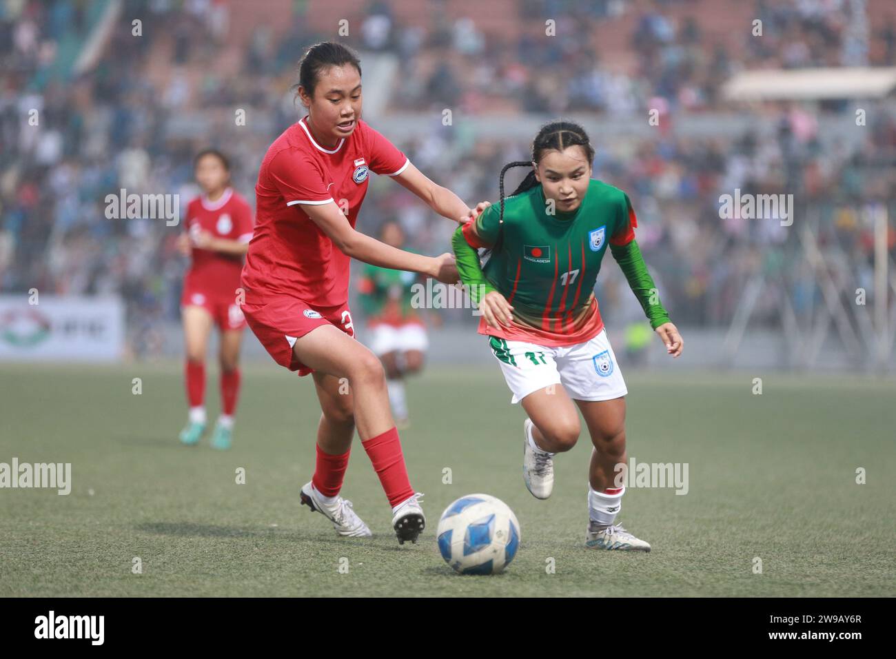 Bangladeshi midfilder Ritu Porna Chakma (Green) try to takes control as ...
