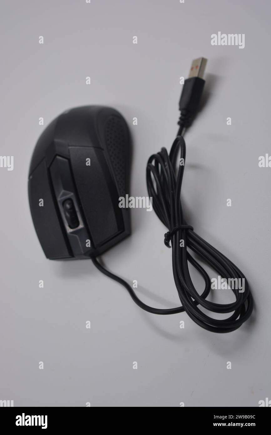 A black, stylish, sporty, computer, wired mouse with a long wire and a ...