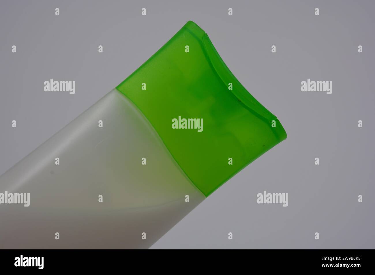 Hygiene products, clear plastic bottle with green plastic cap with ...