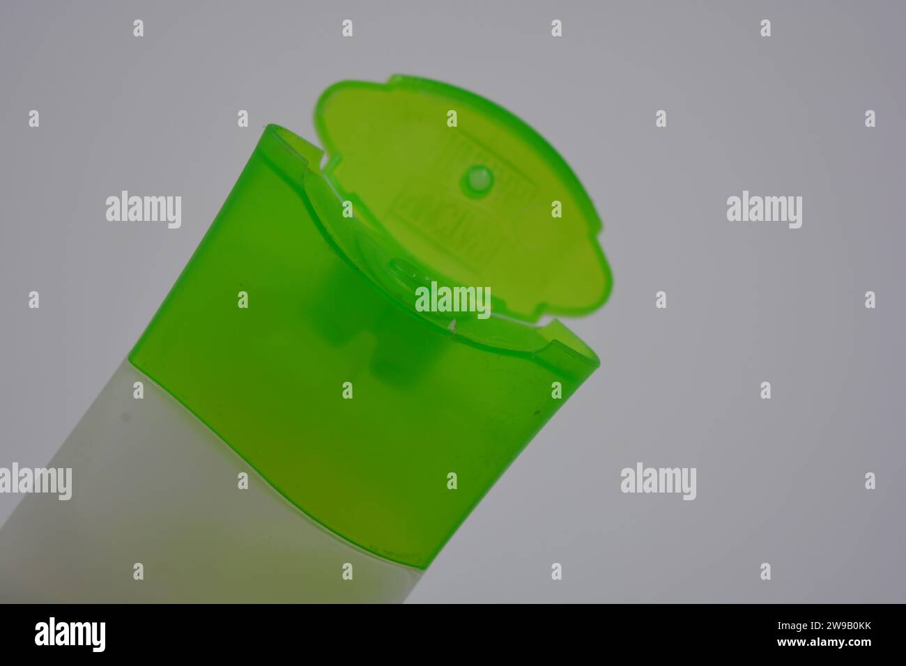 Hygiene products, clear plastic bottle with green plastic cap with ...