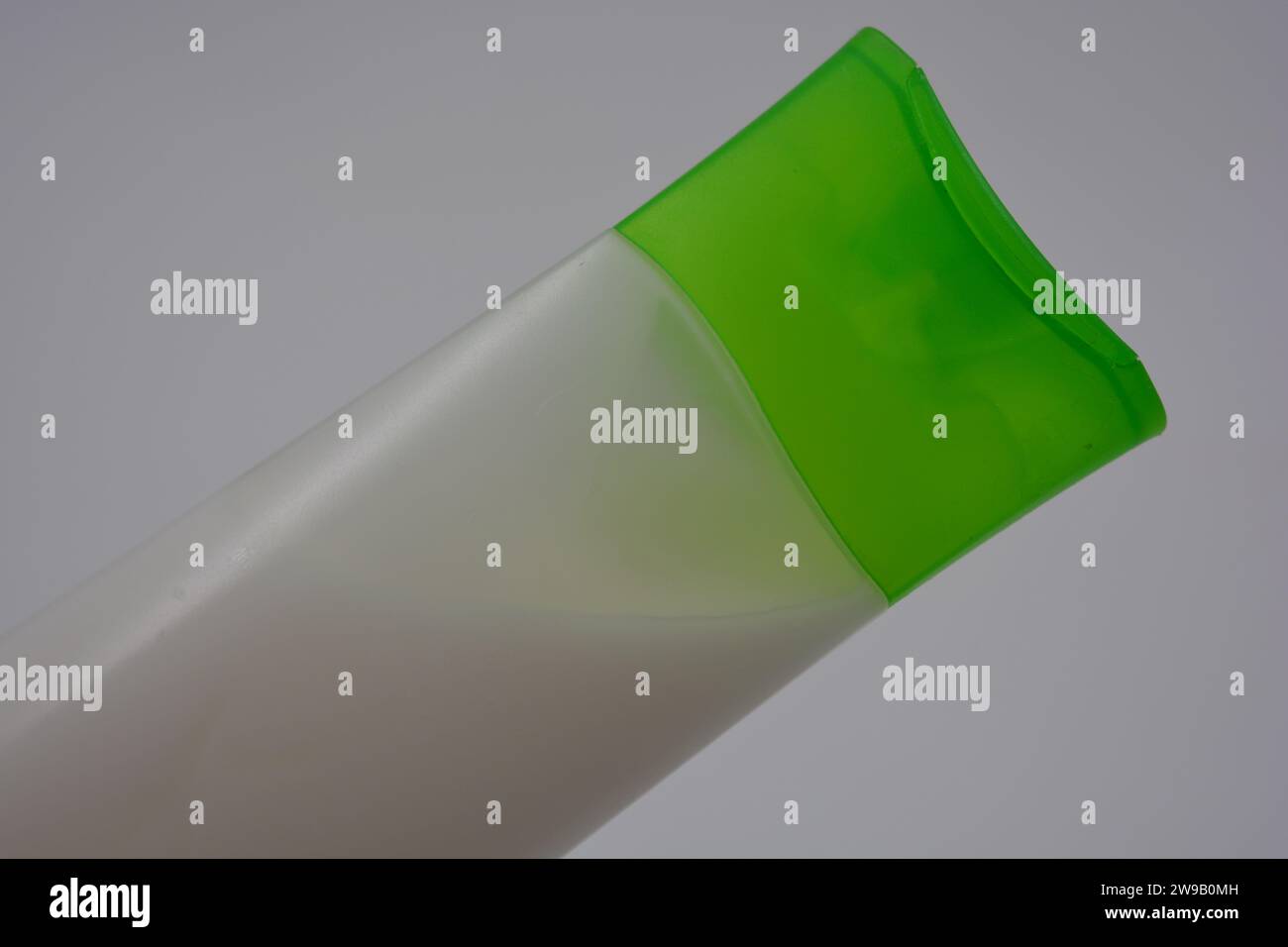 Hygiene products, clear plastic bottle with green plastic cap with ...