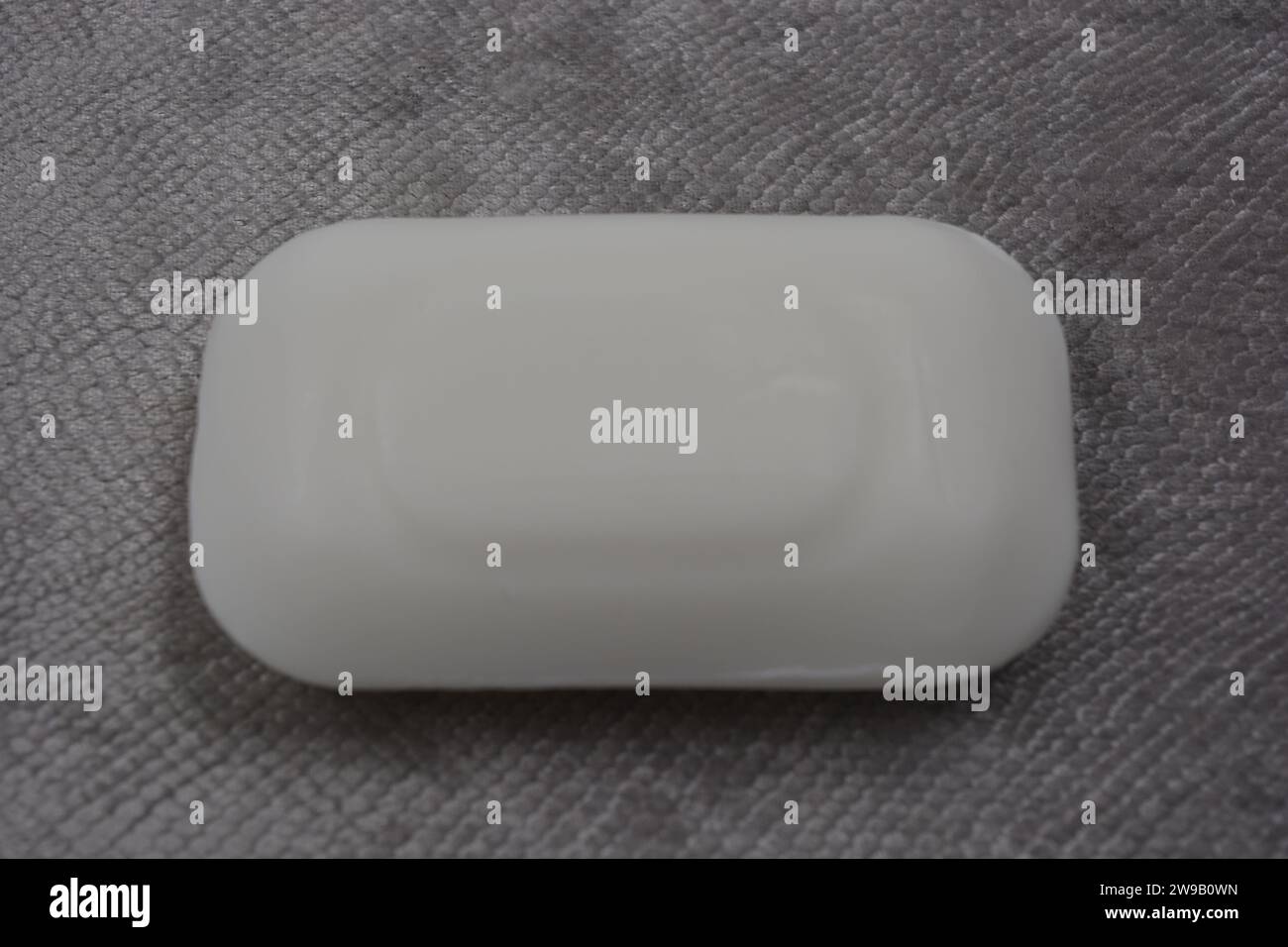 Beautiful, stylish, white bar of soap without logo and name placed on a ...