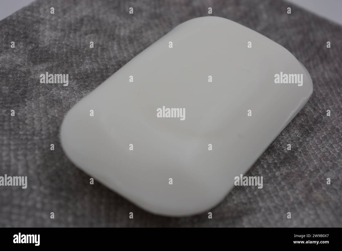 Beautiful, stylish, white bar of soap without logo and name placed on a ...