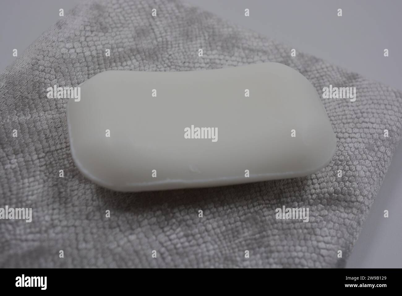 Beautiful, stylish, white bar of soap without logo and name placed on a ...