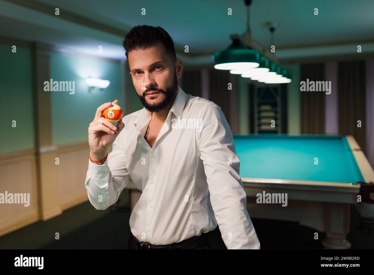 Young man standing at pool table hi-res stock photography and images ...