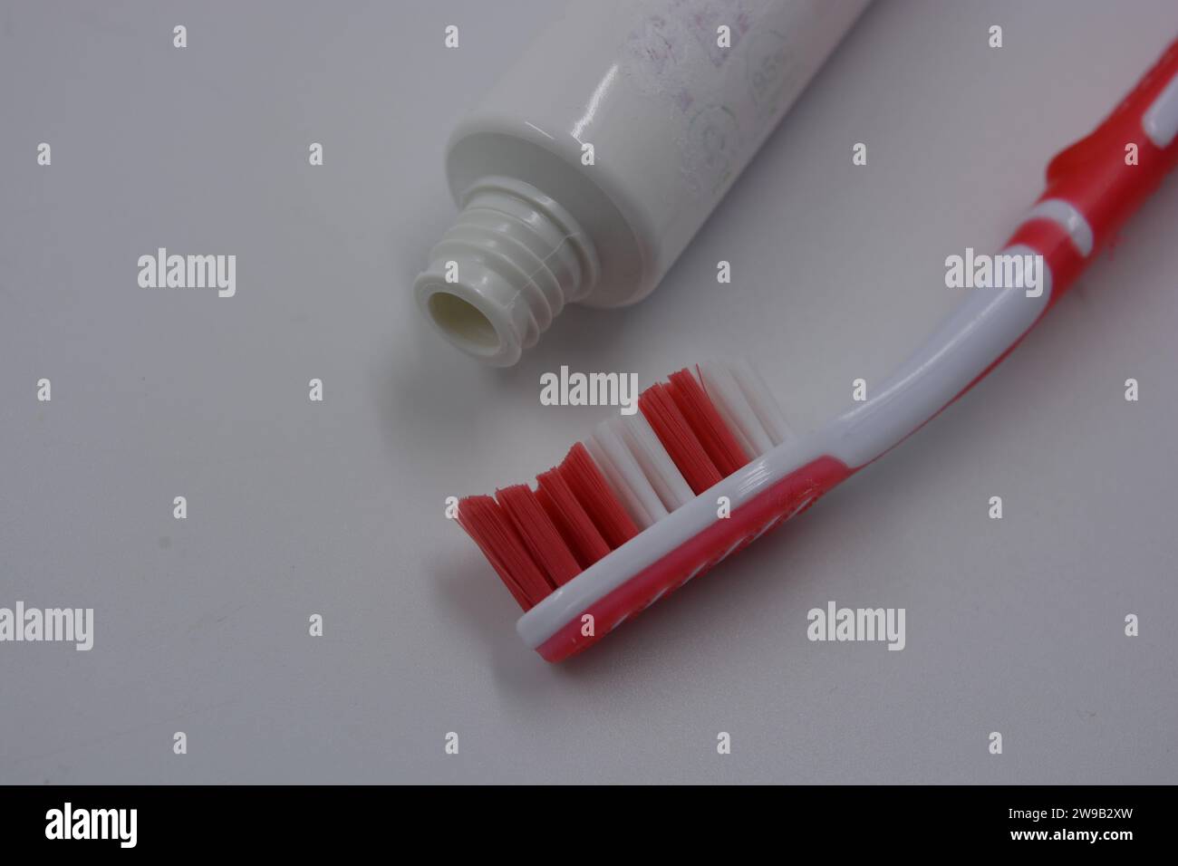 Personal hygiene products, a new plastic toothbrush with red and white ...