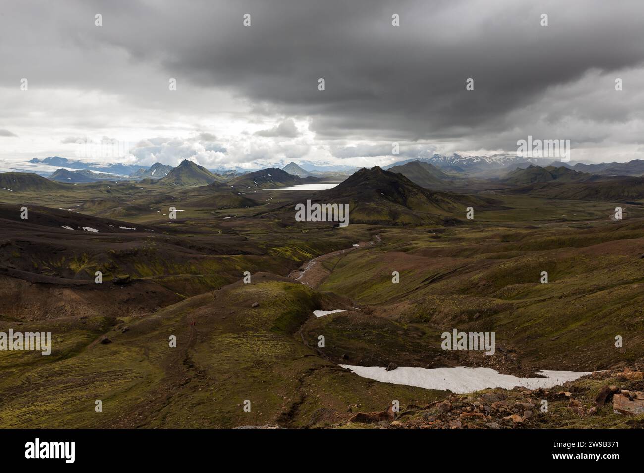 Dramatic Iceland scenery with green mountains covered with thick ...