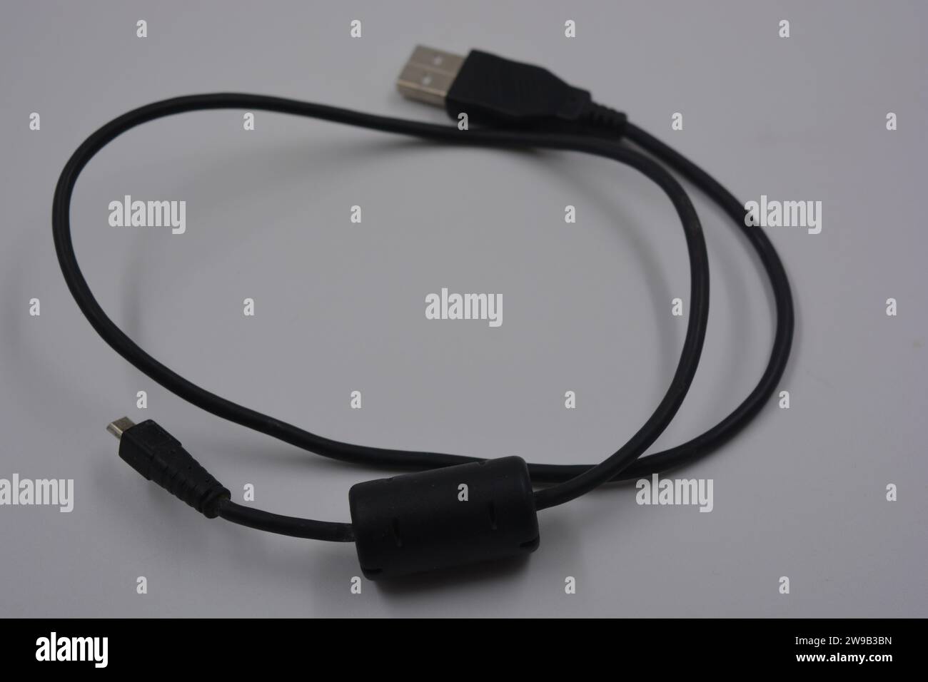 Computer equipment, a long, black micro USB cable from a digital camera ...