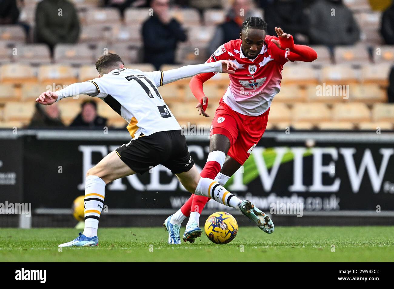 Devante Cole #44 of Barnsley takes on Alfie Devine #11 of Port Vale ...