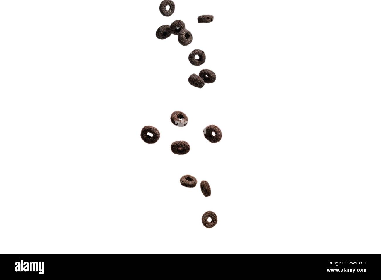 Chocolate rings cereal spill out into a bowl. Breakfast. Isolated on a ...