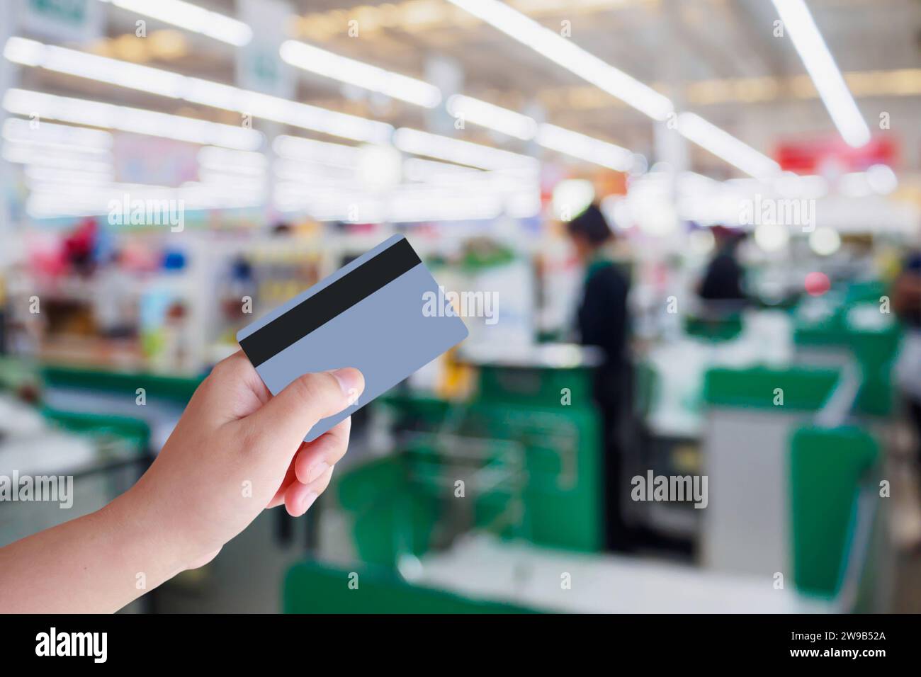 paying using credit card at supermarket checkout cashier counter in ...