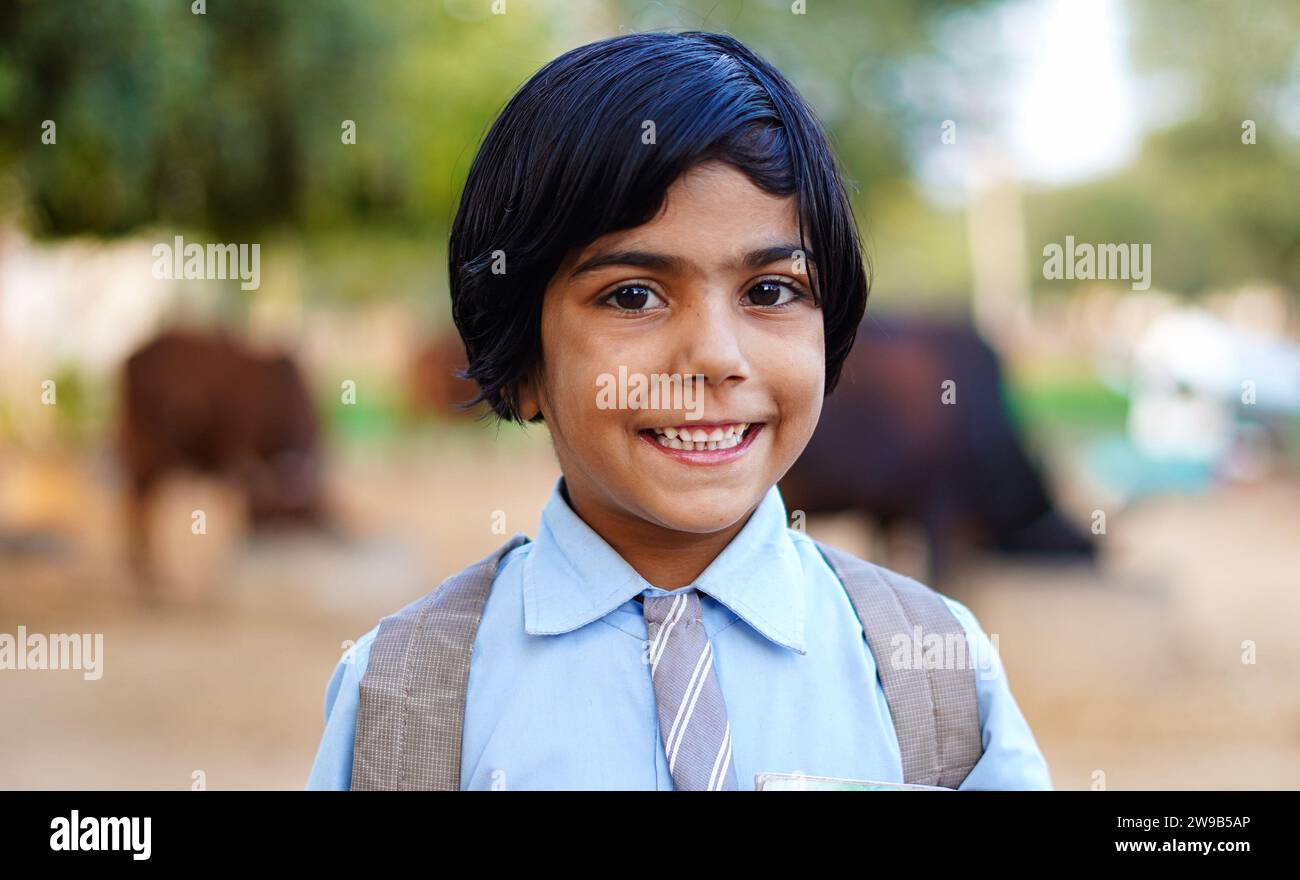 Smiling student girl wearing school backpack and holding exercise book ...