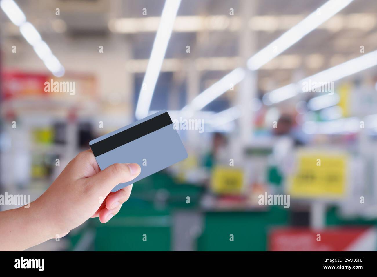 paying using credit card at supermarket checkout cashier counter in ...