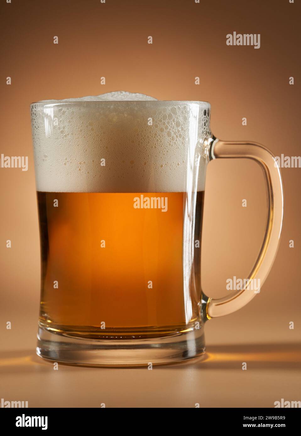 Cold blonde beer in a mug, isolated over beige background Stock Photo ...