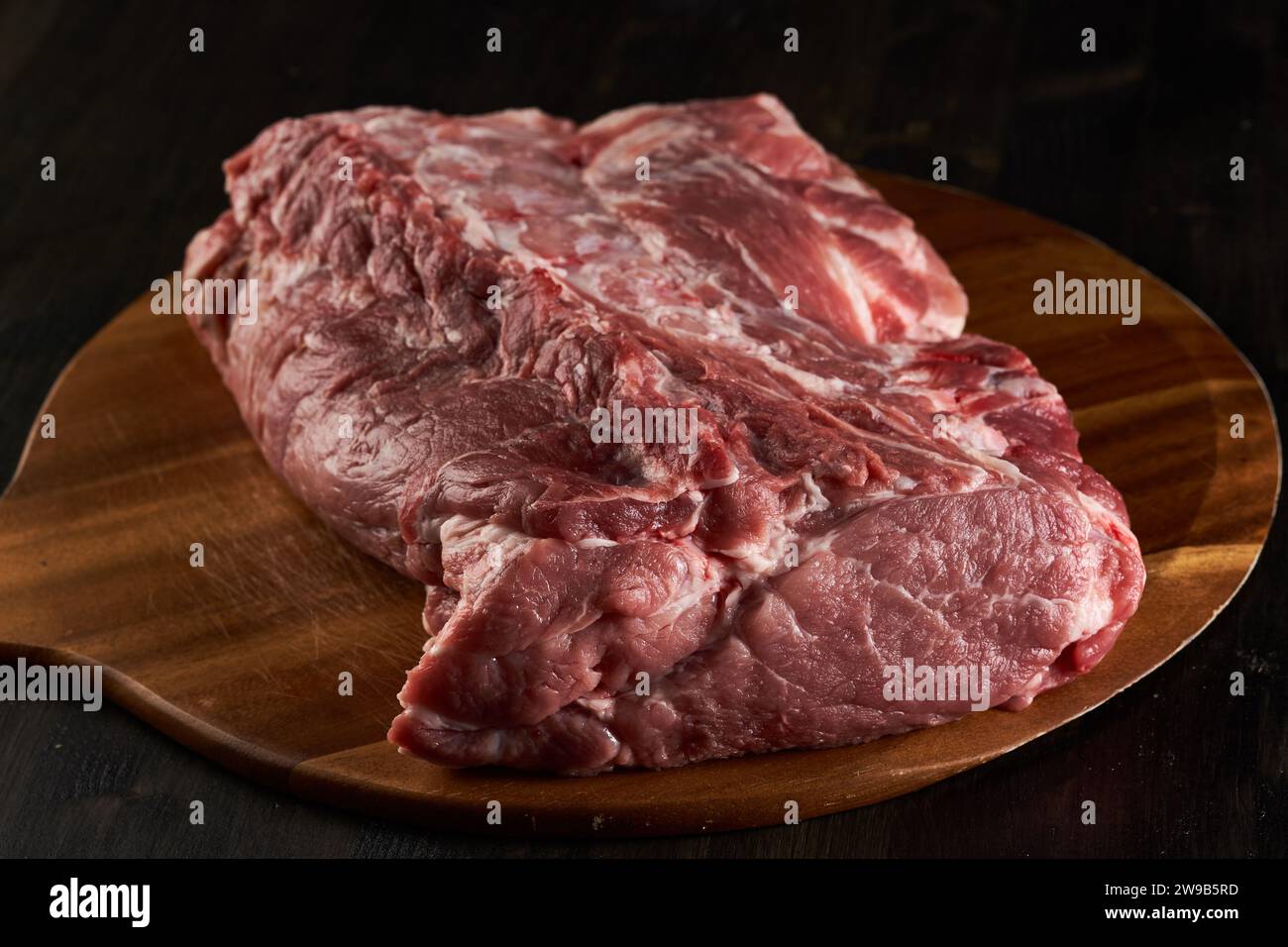 Pork hind leg with plenty of ham, raw, on a wooden chopping board Stock ...