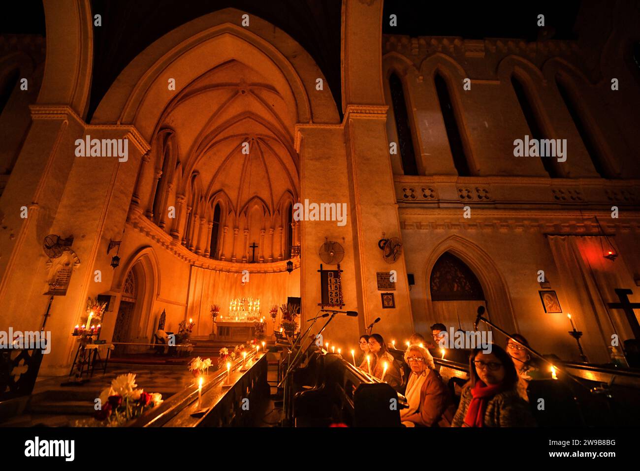 Christian devotees attend a Midnight Mass at St. James Cathedral Church ...
