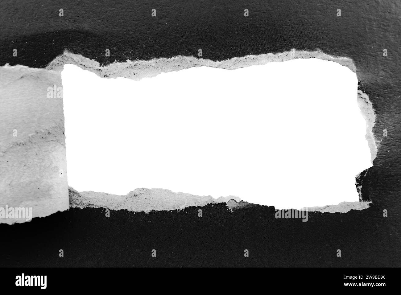 Black paper background with copy space. Hole on a crumpled dark sheet ...