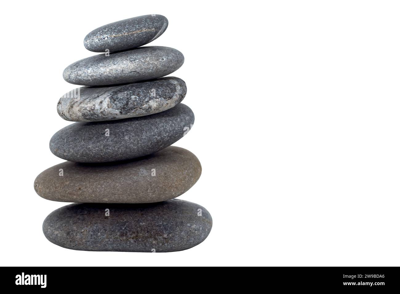 Natural gray stones lie on top of each other on a white background ...