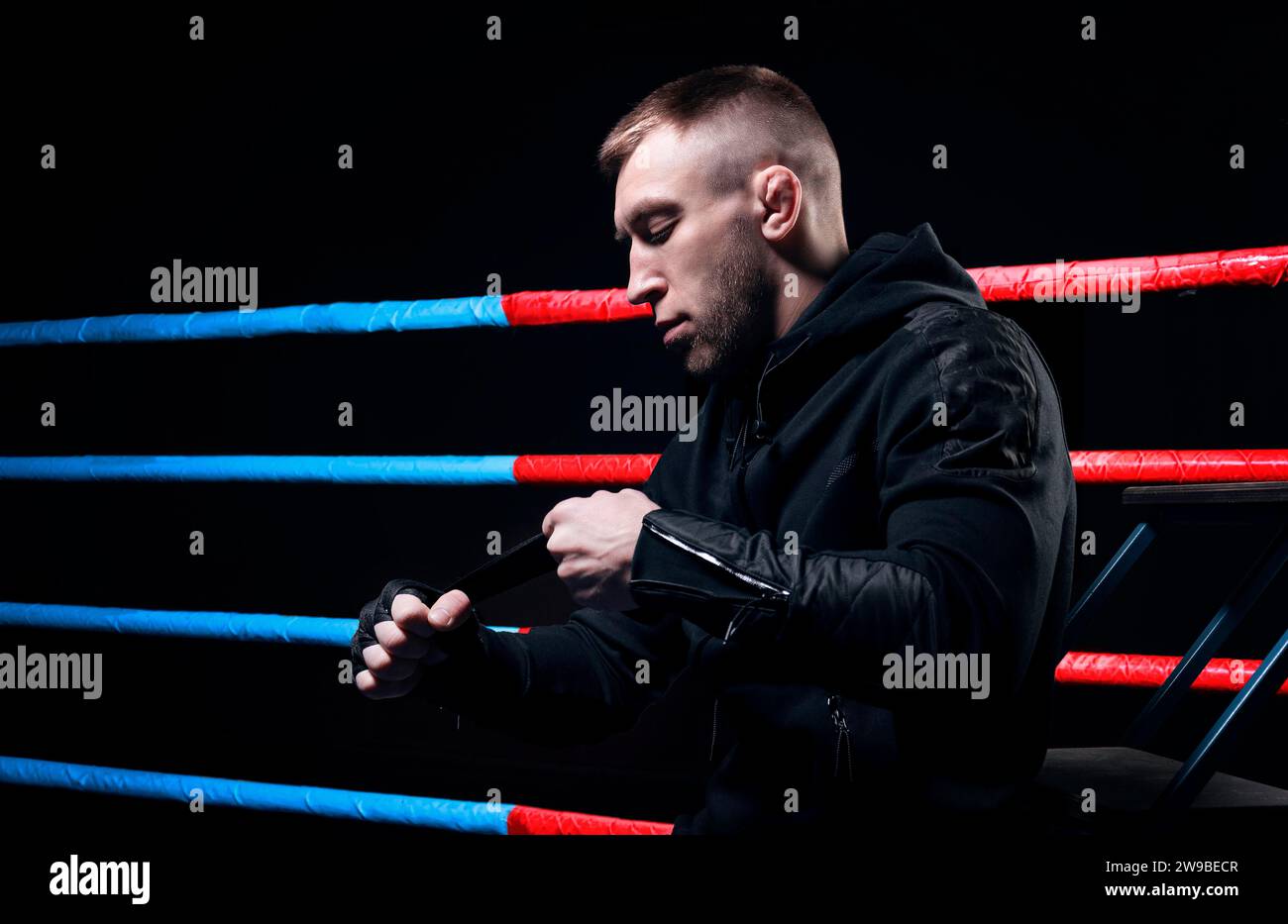 Mixed martial artist wraps bandages around his fist. Concept of mma ...