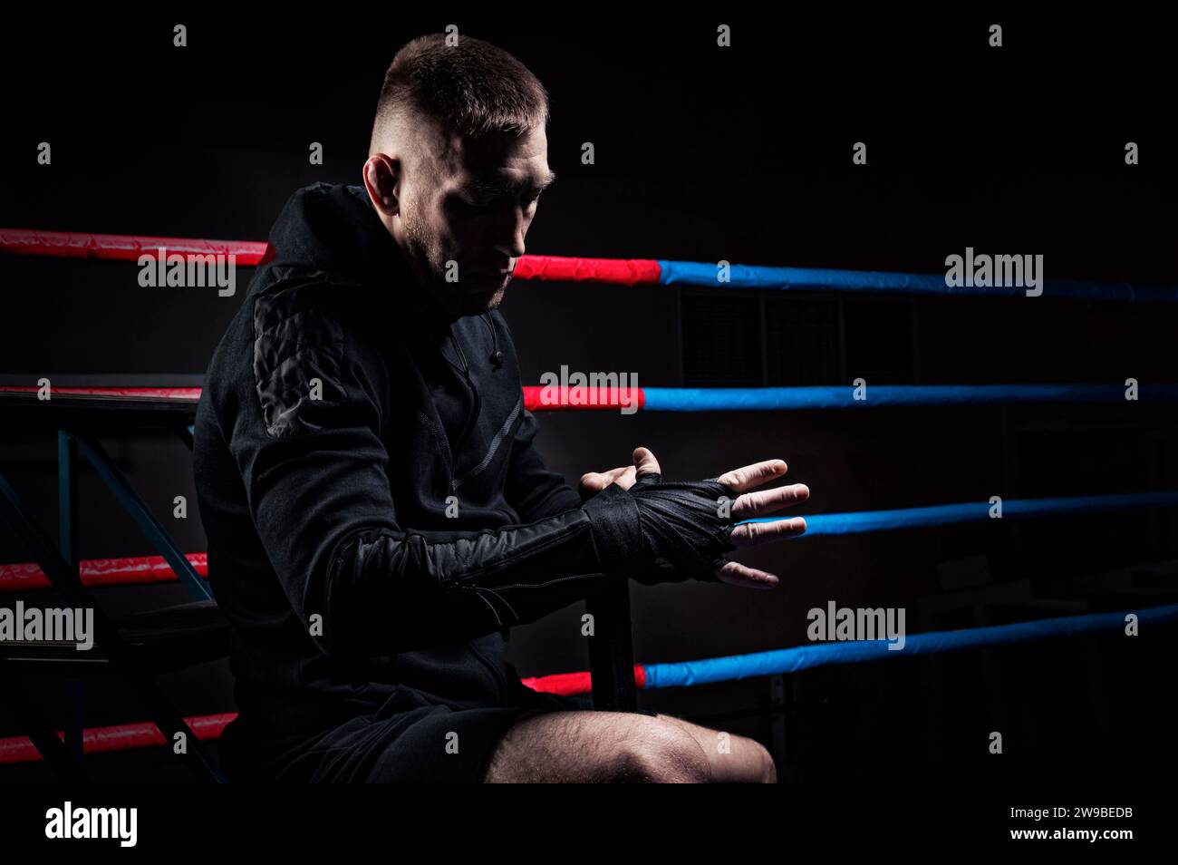 Mixed martial artist wraps bandages around his fist. Concept of mma ...