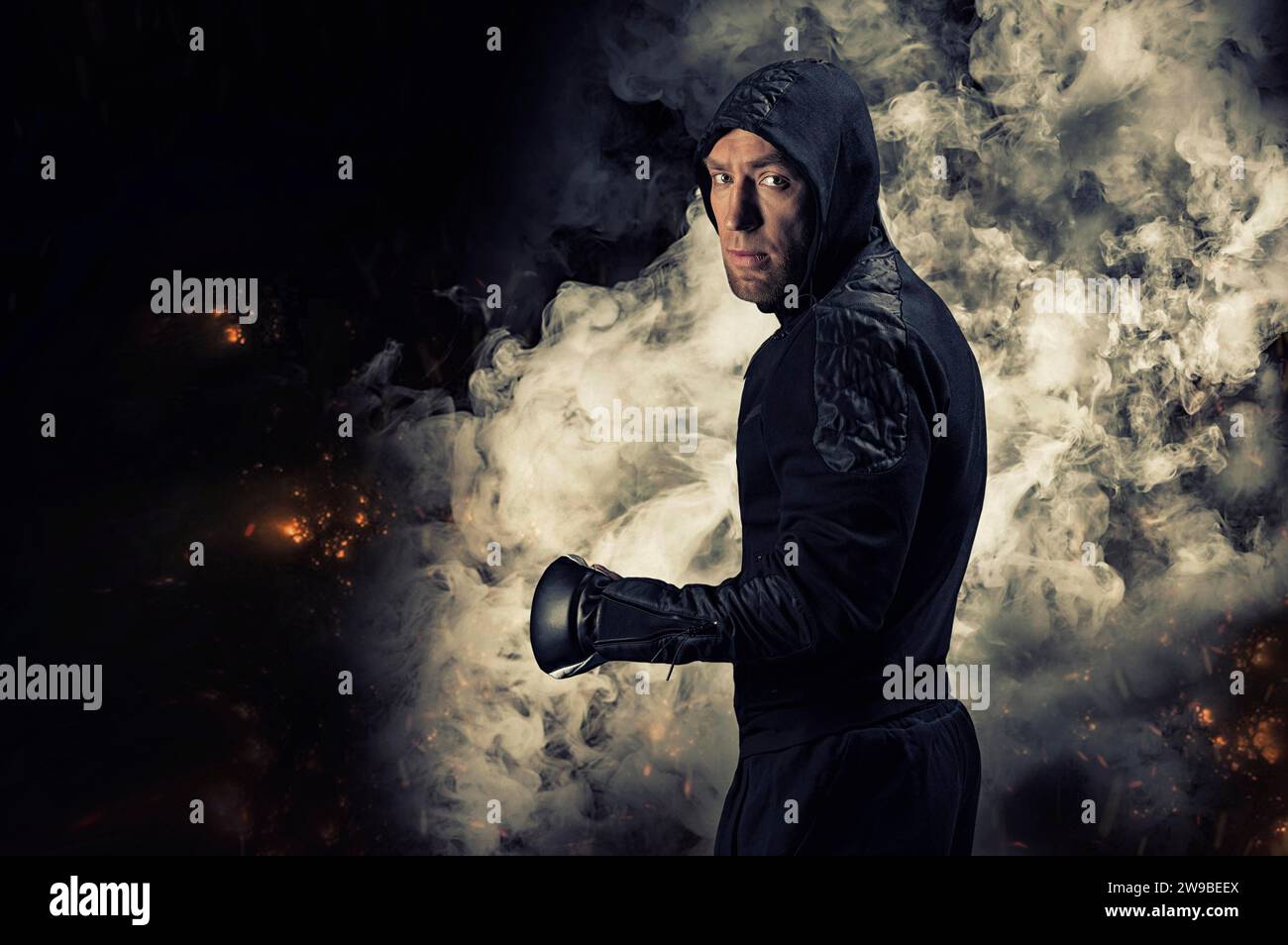 Mixed martial artist goes to battle in a sweatshirt amid fire and smoke ...