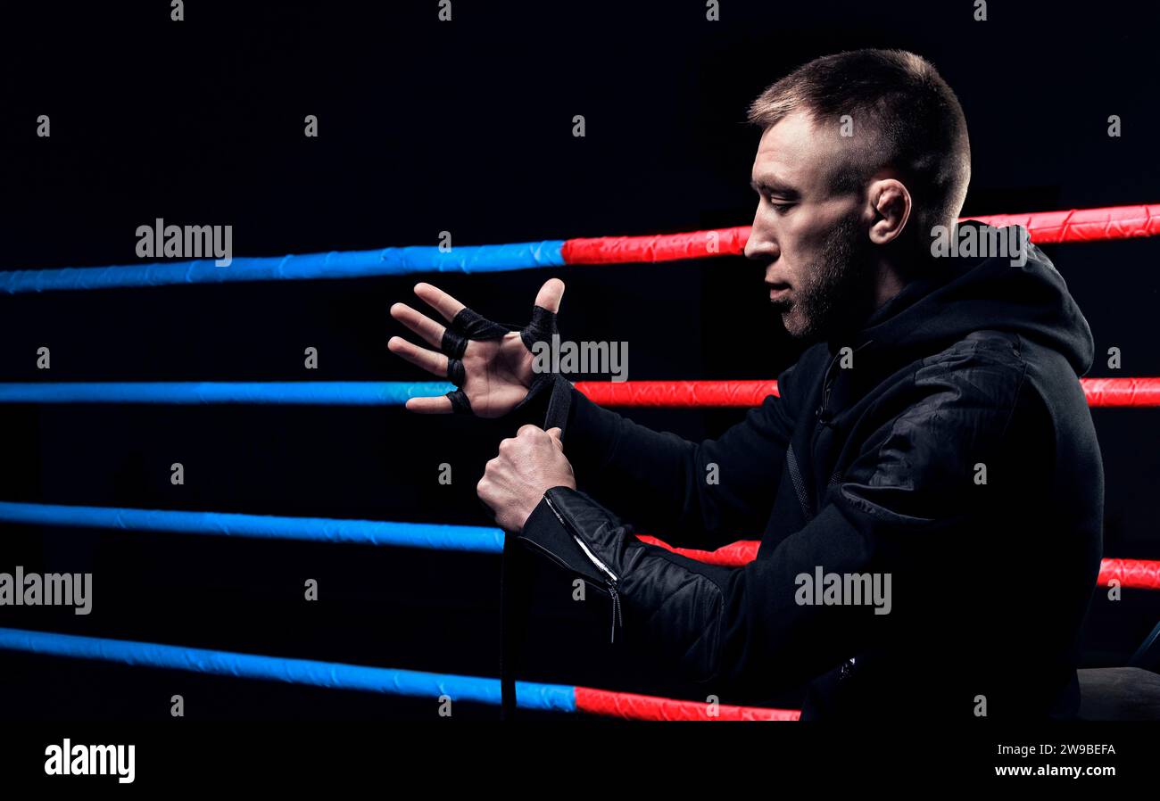 Mixed martial artist wraps bandages around his fist. Concept of mma ...