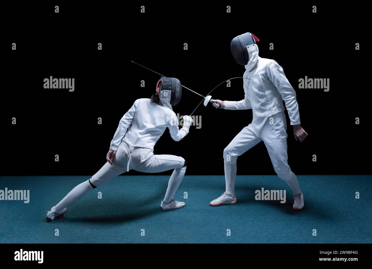 Two fencers are fighting in a tournament. The concept of fencing. Mixed ...