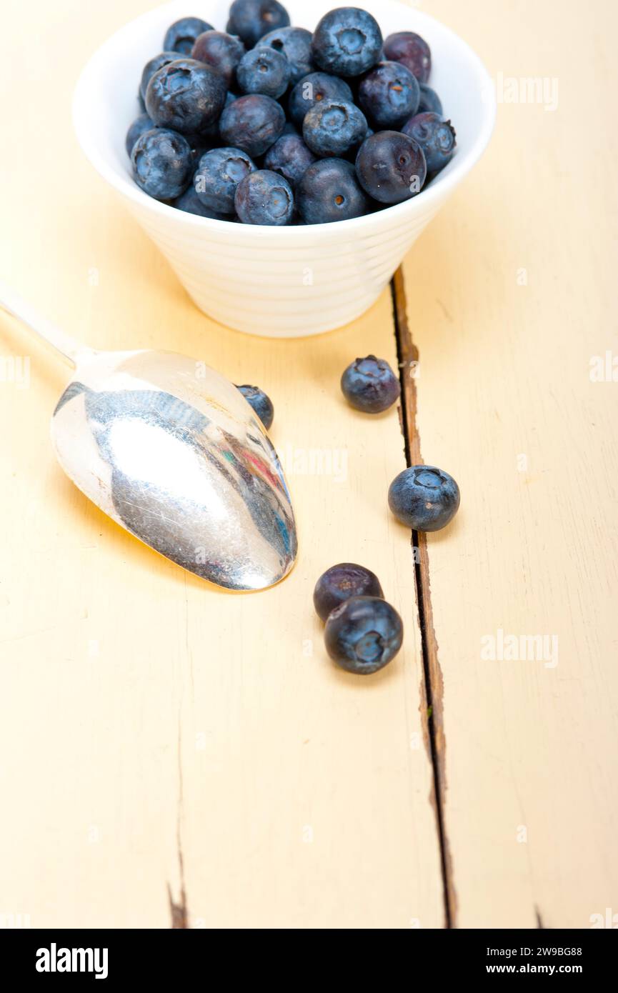 Fresh blueberry on a bowl with silver spoon over wood table, food ...