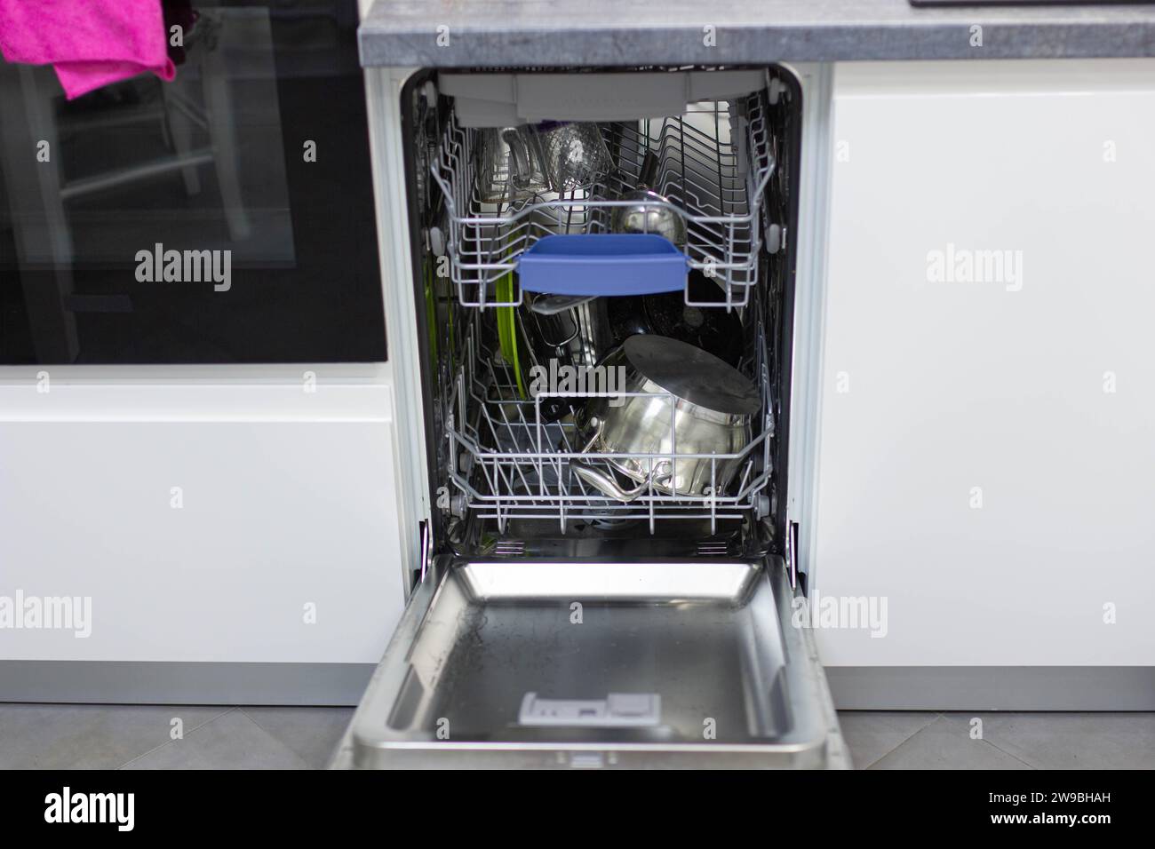 White modern dishwasher in the interior of a white kitchen, kitchen ...