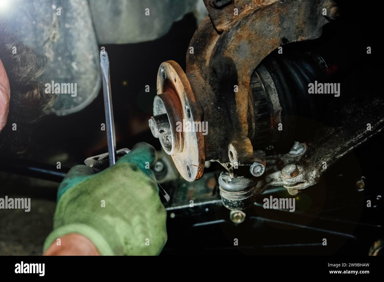 Car hub replacement, car repair, mechanic, glove, screws, motor ...