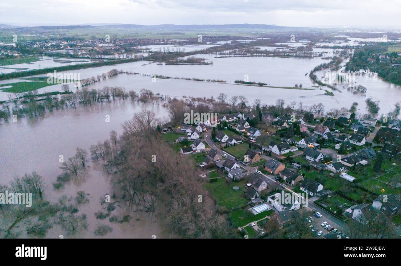 Sarstedt, Germany. 26th Dec, 2023. Floodwater flows around the village ...