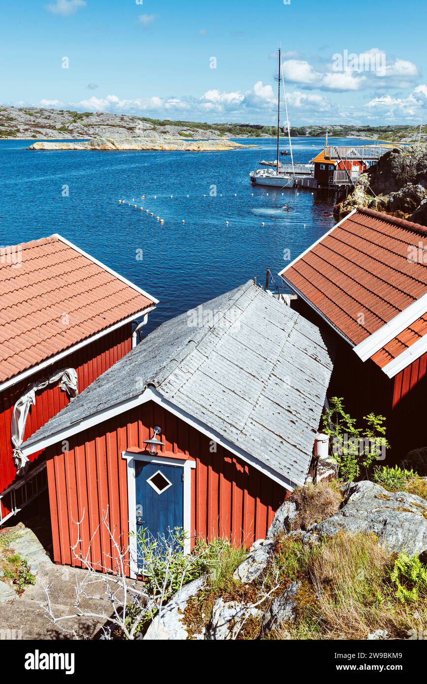 Traditional red Swedish wooden huts in front of the bathing place in ...