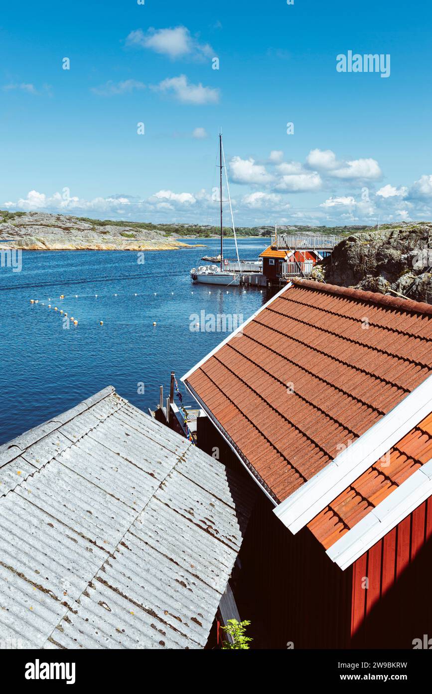 Traditional red Swedish wooden huts in front of the bathing place in ...