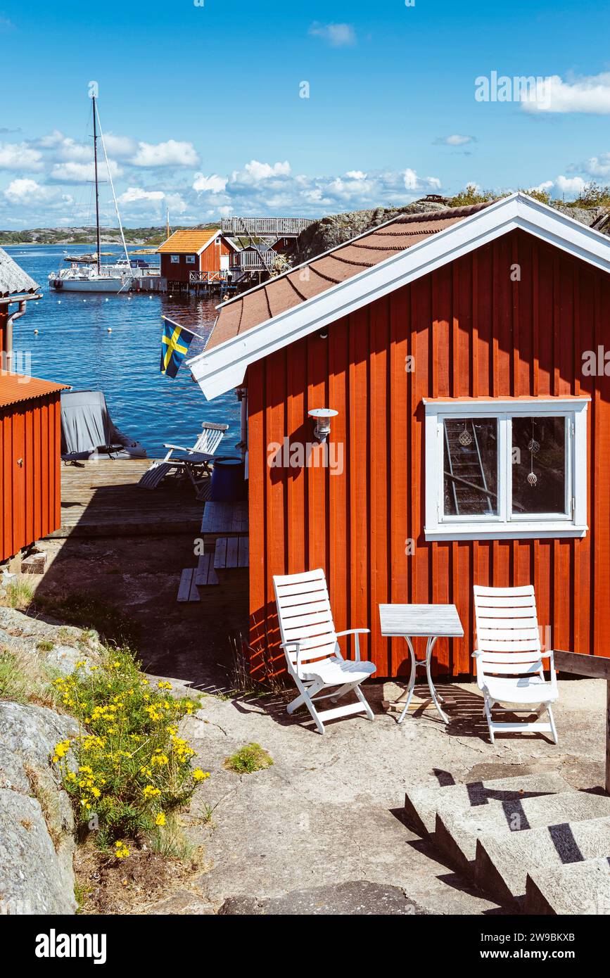 Traditional red Swedish wooden huts in front of the bathing place in ...