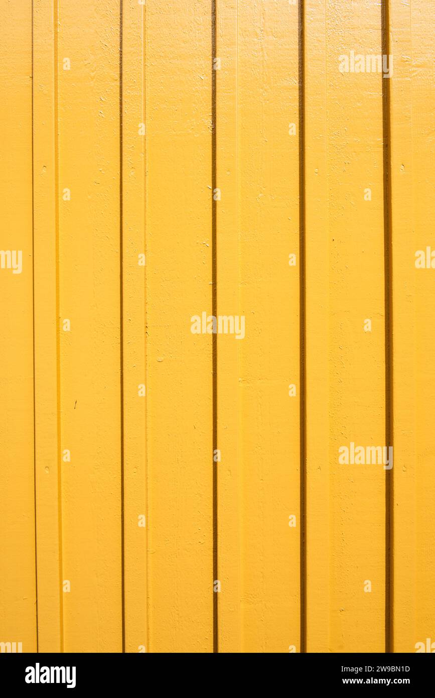 Yellow painted boards of a wooden facade of a typical Swedish wooden ...