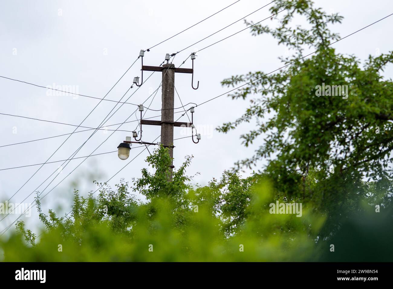 Old electricity power supply pillar. Power line post with electric ...