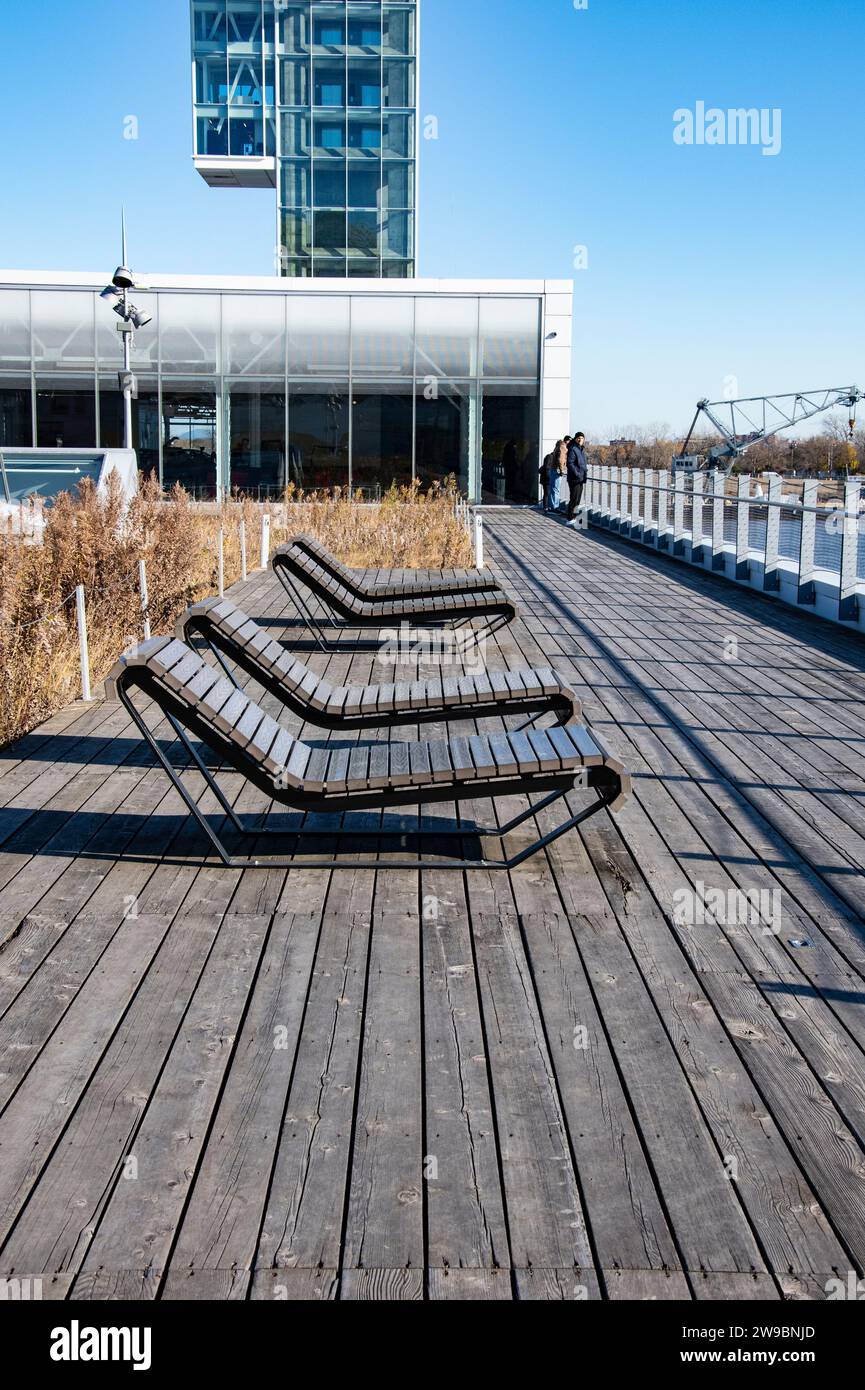 Lounge chairs on the green roof boardwalk at the Grand Quay in Montreal ...
