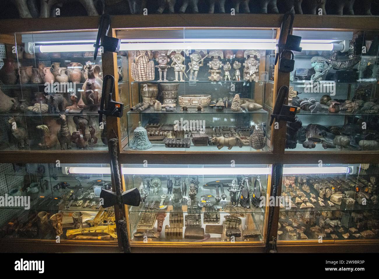 A collection of old antique trinkets and souvenirs in a display cabinet ...